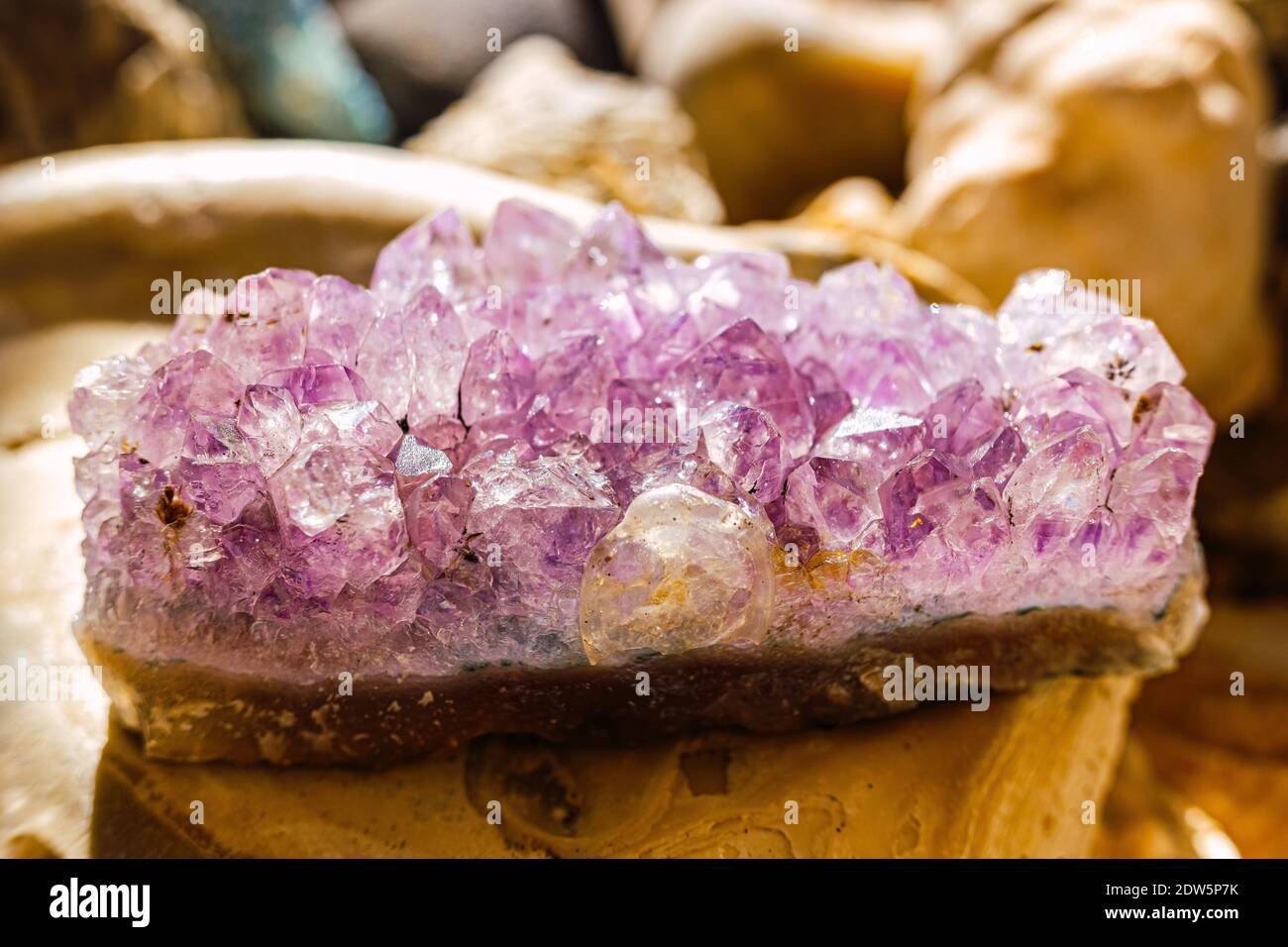 Amethyst rock on the table of a geology student Stock Photo - Alamy