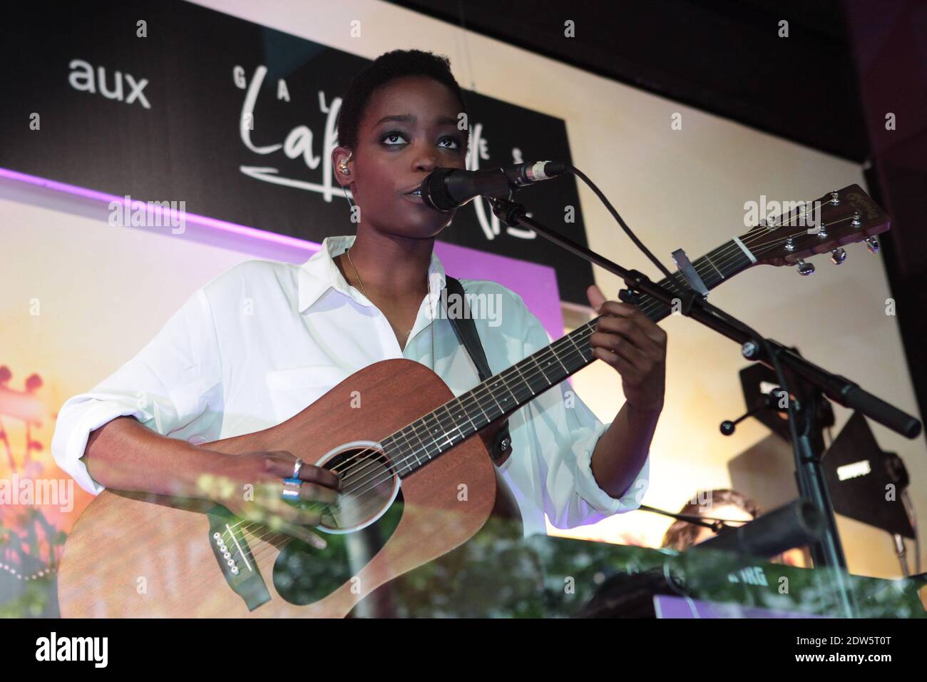 Singer Irma performs behind a window of the Galeries Lafayette ...
