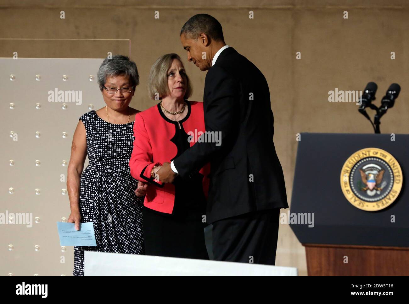 President Barack Obama talks with Ling Young, left, and Alison ...