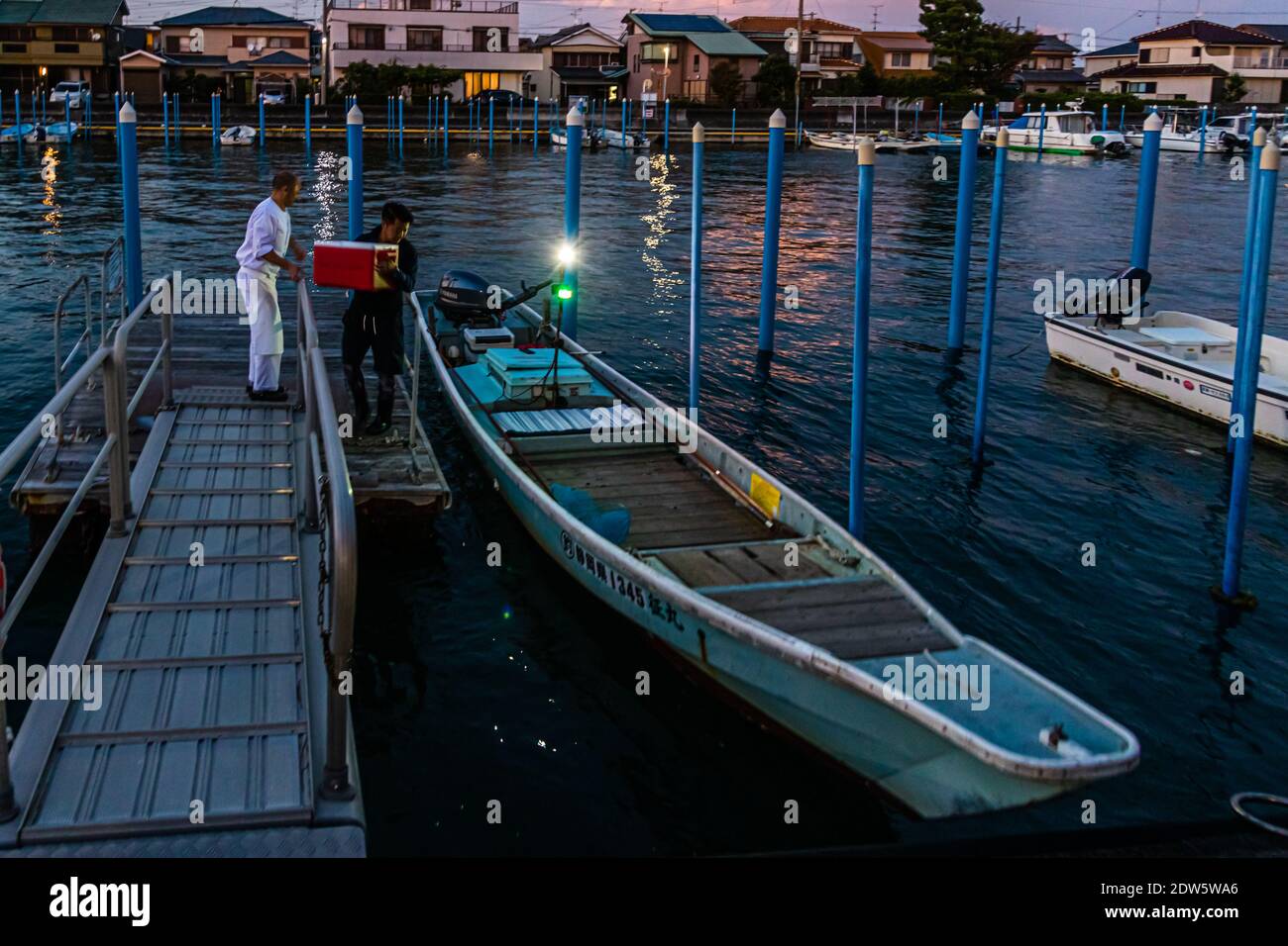 Spearfishing on Lake Hanama, Hamamatsu, Japan. The sun is just setting ...