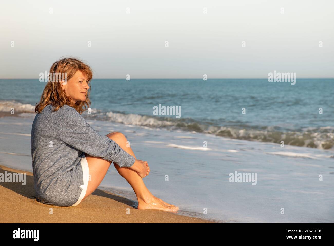 Woman thinking about the beach Stock Photo - Alamy