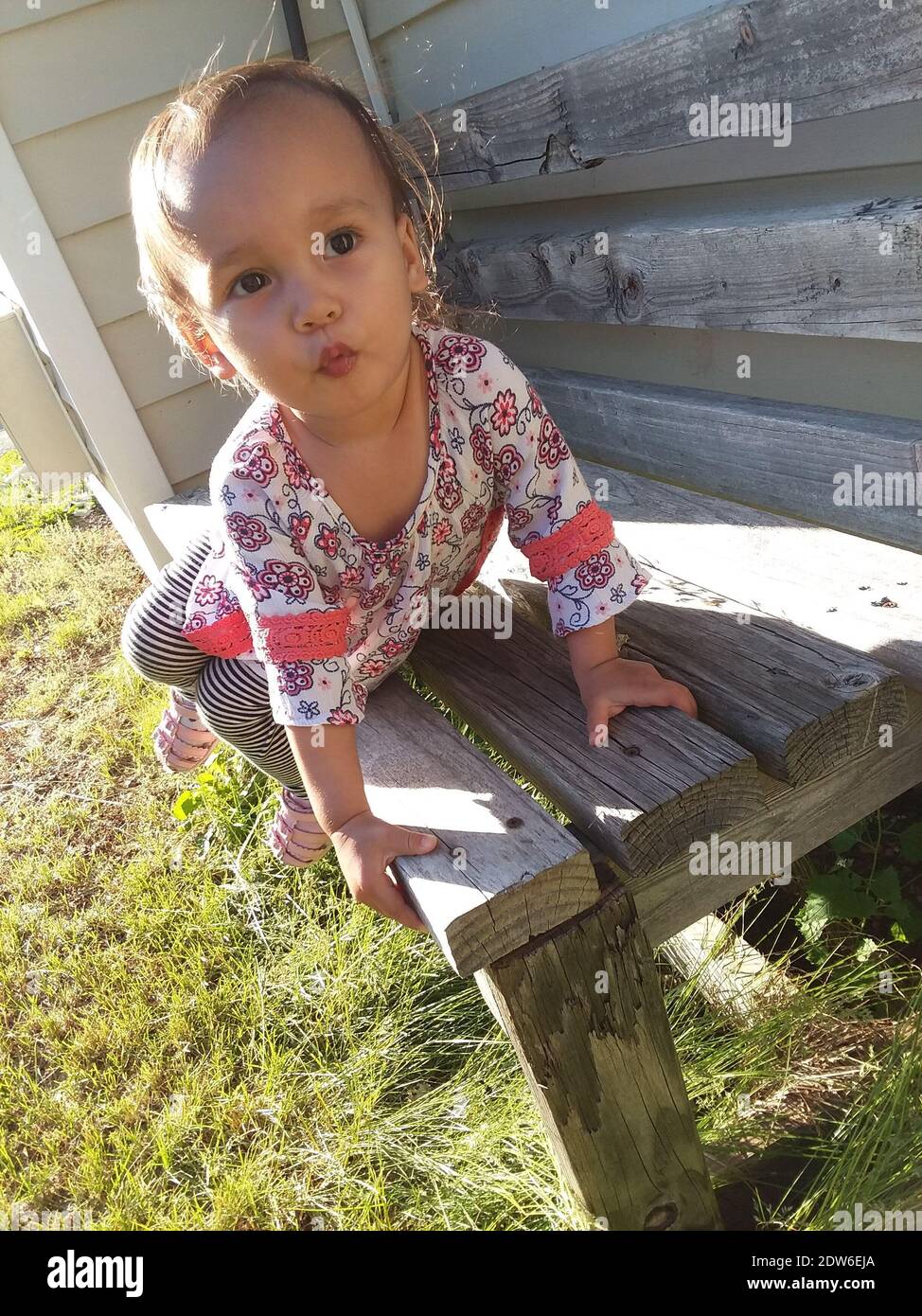 Cute Girl Sitting On Bench Stock Photo - Alamy