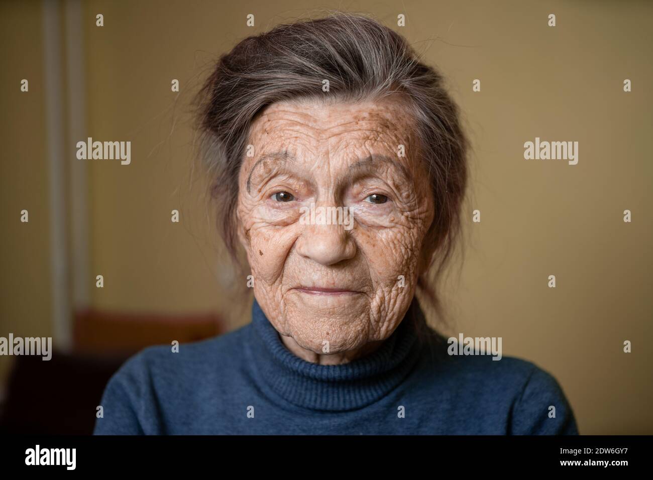 Elderly Caucasian senior grandmother ninety years old looks attentively ...