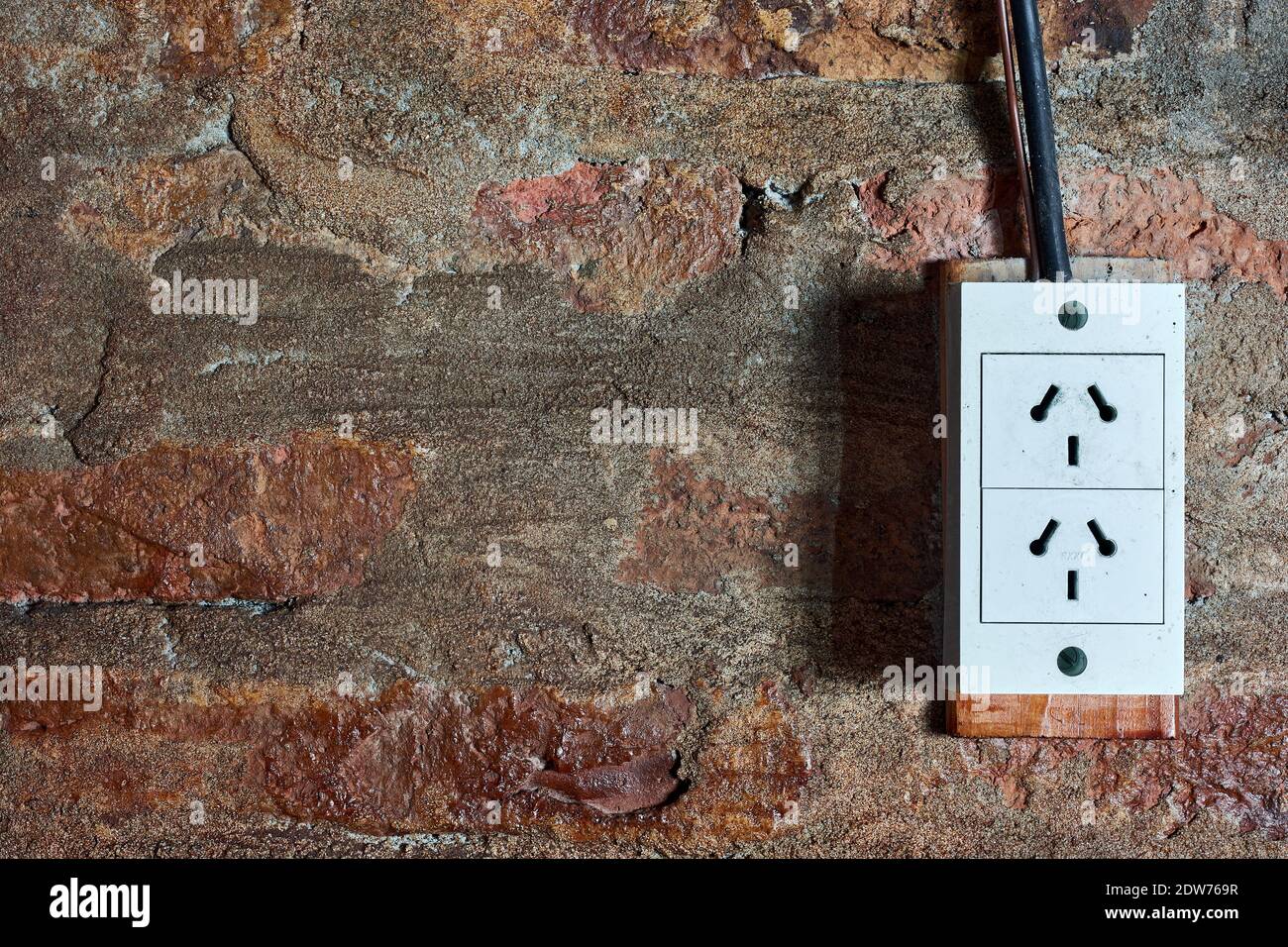 Old plug on background of red brick wall with grunge texture Stock ...