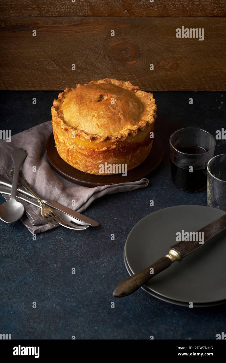 Traditional british raised pork pie with bacon and herbs Stock Photo ...