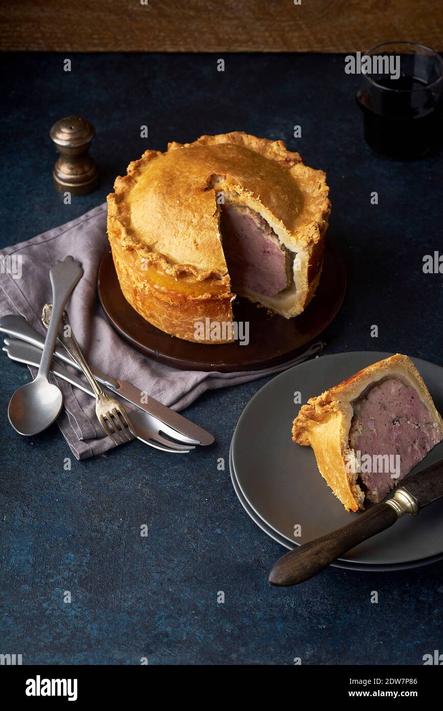 Traditional british raised pork pie with bacon and herbs Stock Photo ...