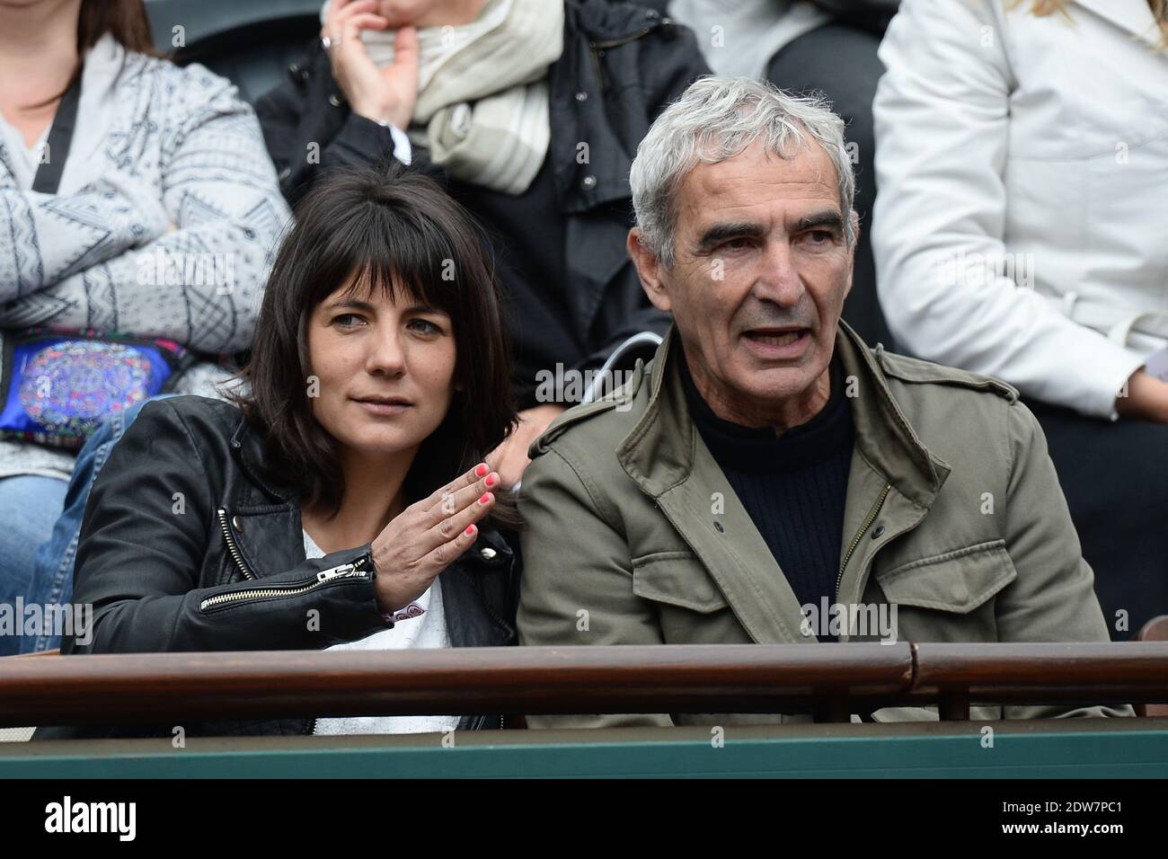 Raymond Domenech and Estelle Denis watch a game during the first round ...