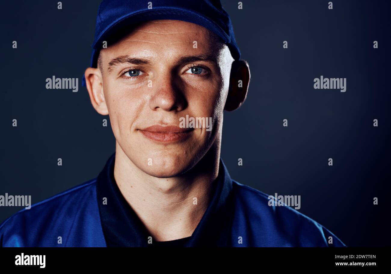 Man in a working uniform blue cap work delivery service Stock Photo - Alamy