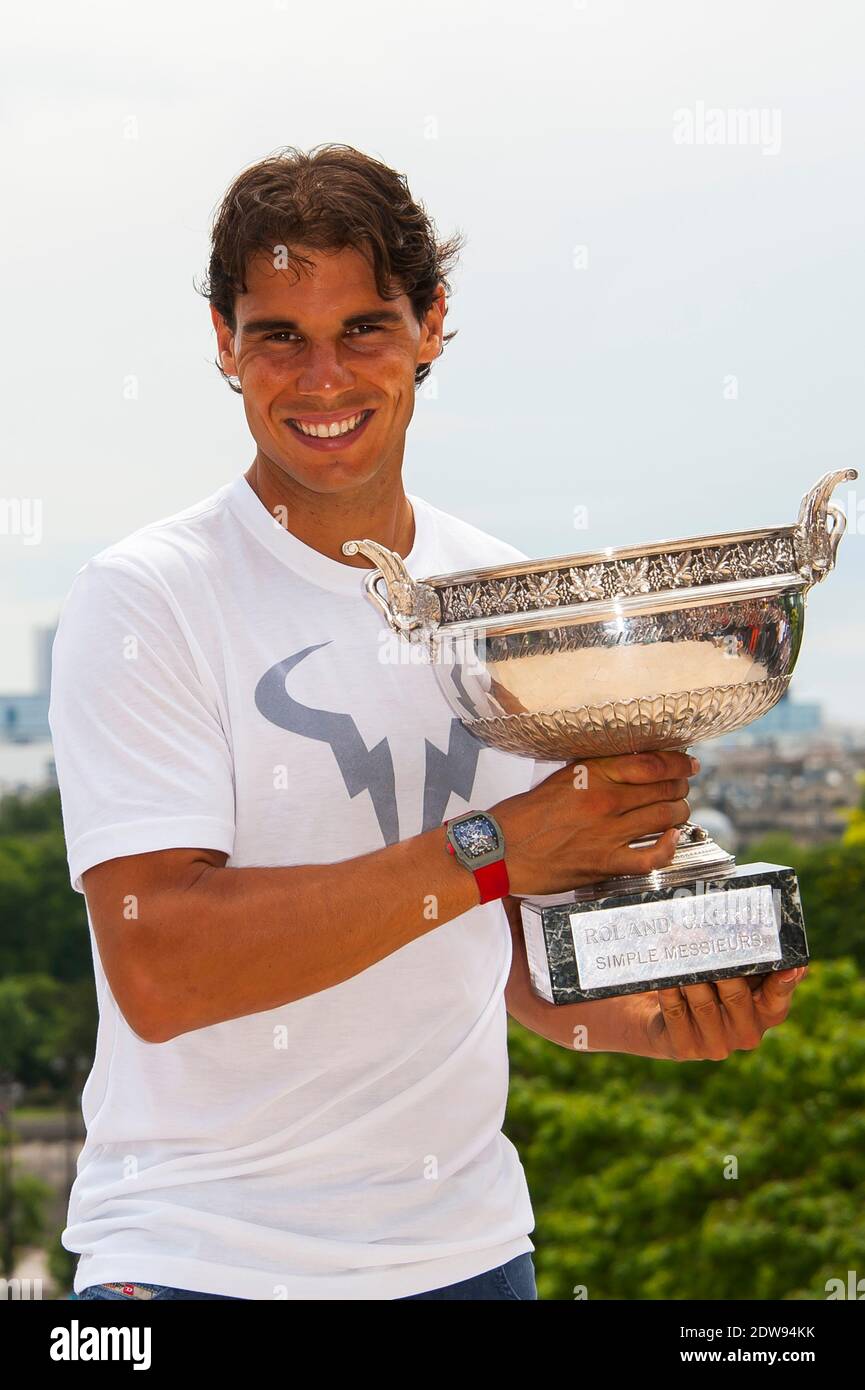 Rafael Nadal holds the championship trophy during a posing session in ...