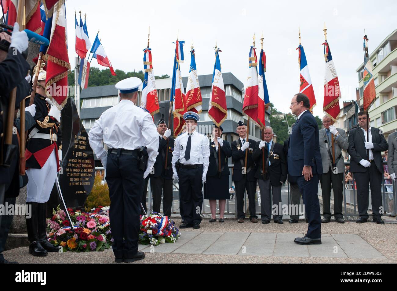 French President Francois Hollande, flanked by Veterans, observes a ...