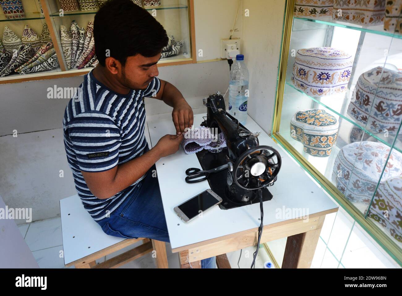An Omani tailor working on a traditional Omani hat ( called Kuma ) in ...