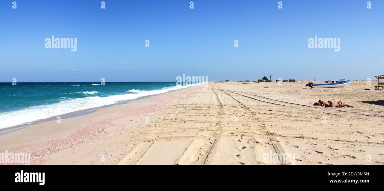 Tourist sunbathing on the beautiful beach in Ras Al Hadd in Oman Stock ...