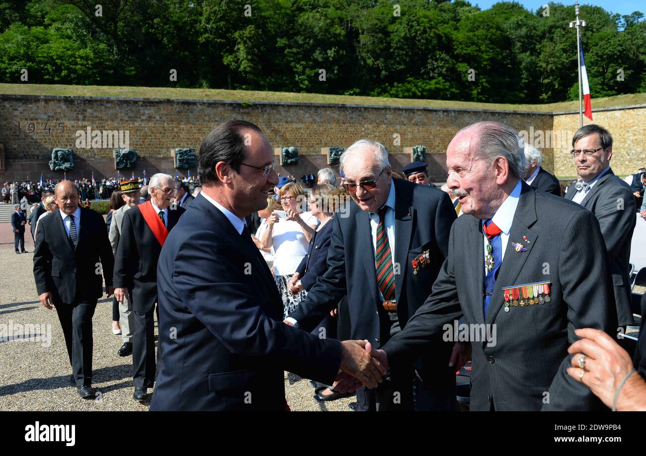 President Francois Hollande shake hands with veterans at a ceremony ...