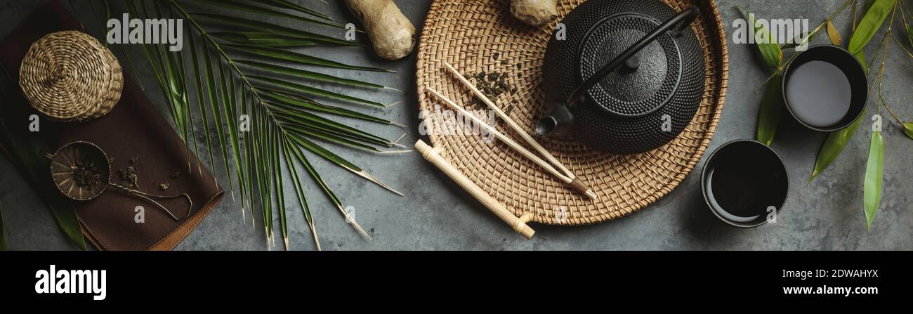 Traditional Asian tea ceremony arrangement. Iron teapot, cups, dried ...