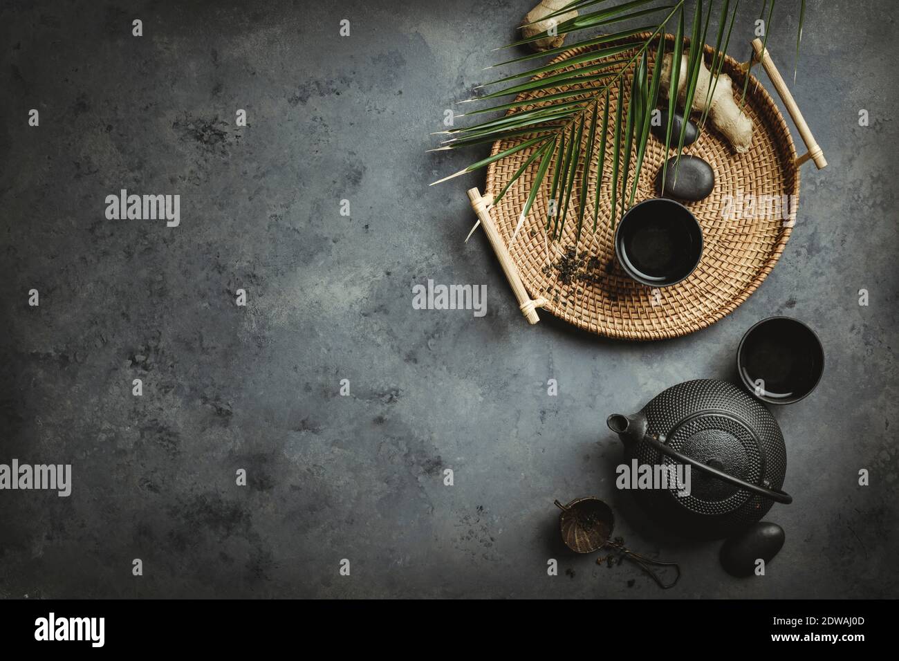 Traditional Asian tea ceremony arrangement. Iron teapot, cups, dried ...