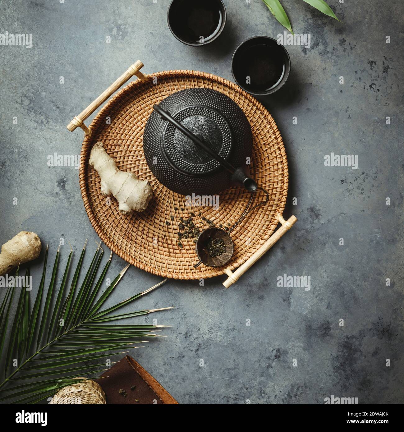 Traditional Asian tea ceremony arrangement. Iron teapot, cups, dried ...