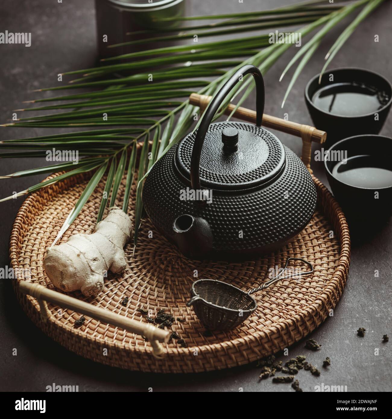 Traditional Asian tea ceremony arrangement. Iron teapot, cups, dried ...