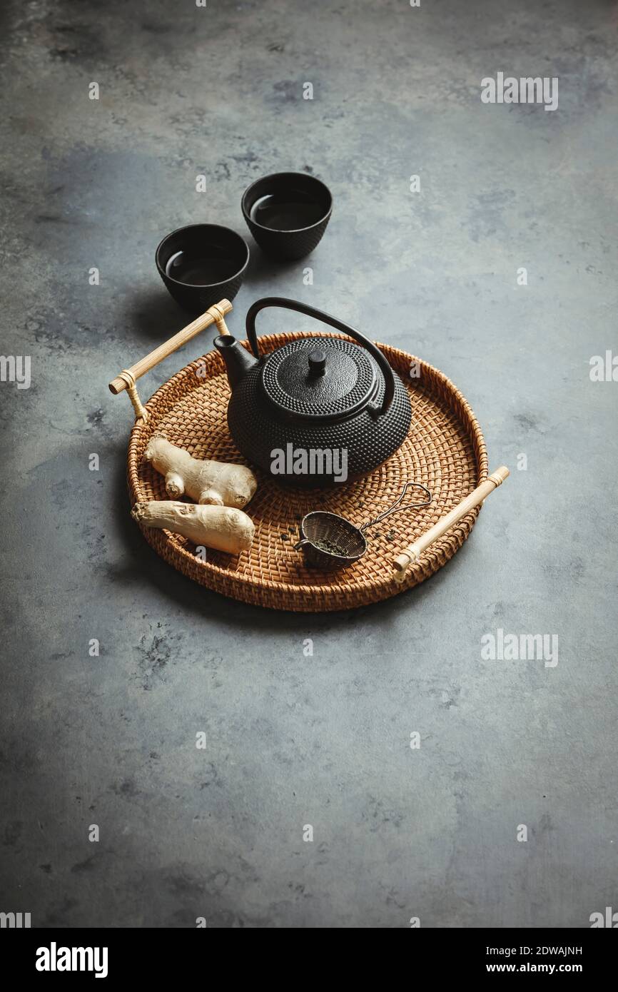 Traditional Asian tea ceremony arrangement. Iron teapot, cups, dried ...