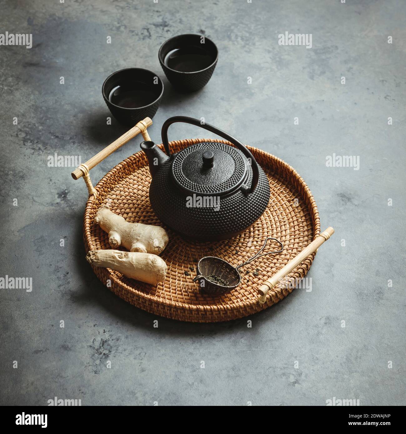 Traditional Asian tea ceremony arrangement. Iron teapot, cups, dried ...