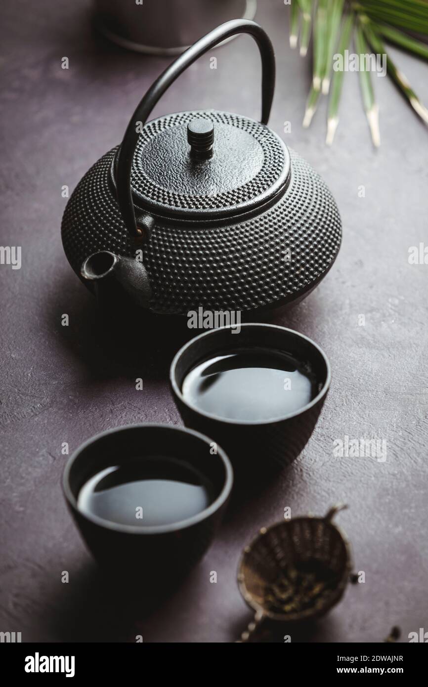 Traditional Asian tea ceremony arrangement. Iron teapot, cups, dried ...