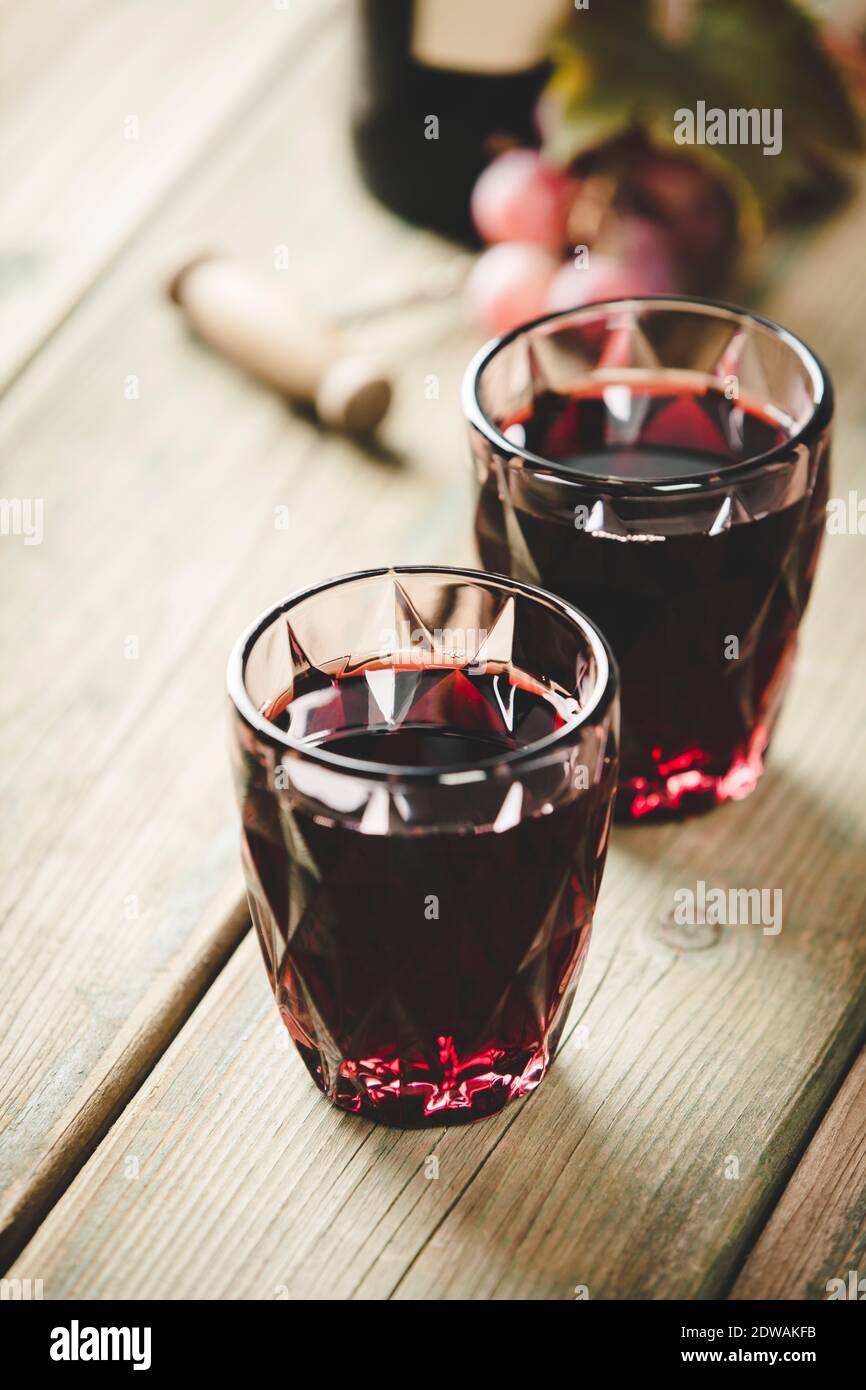 Red wine composition. Red wine glasses, bottle of wine, grapes and ...