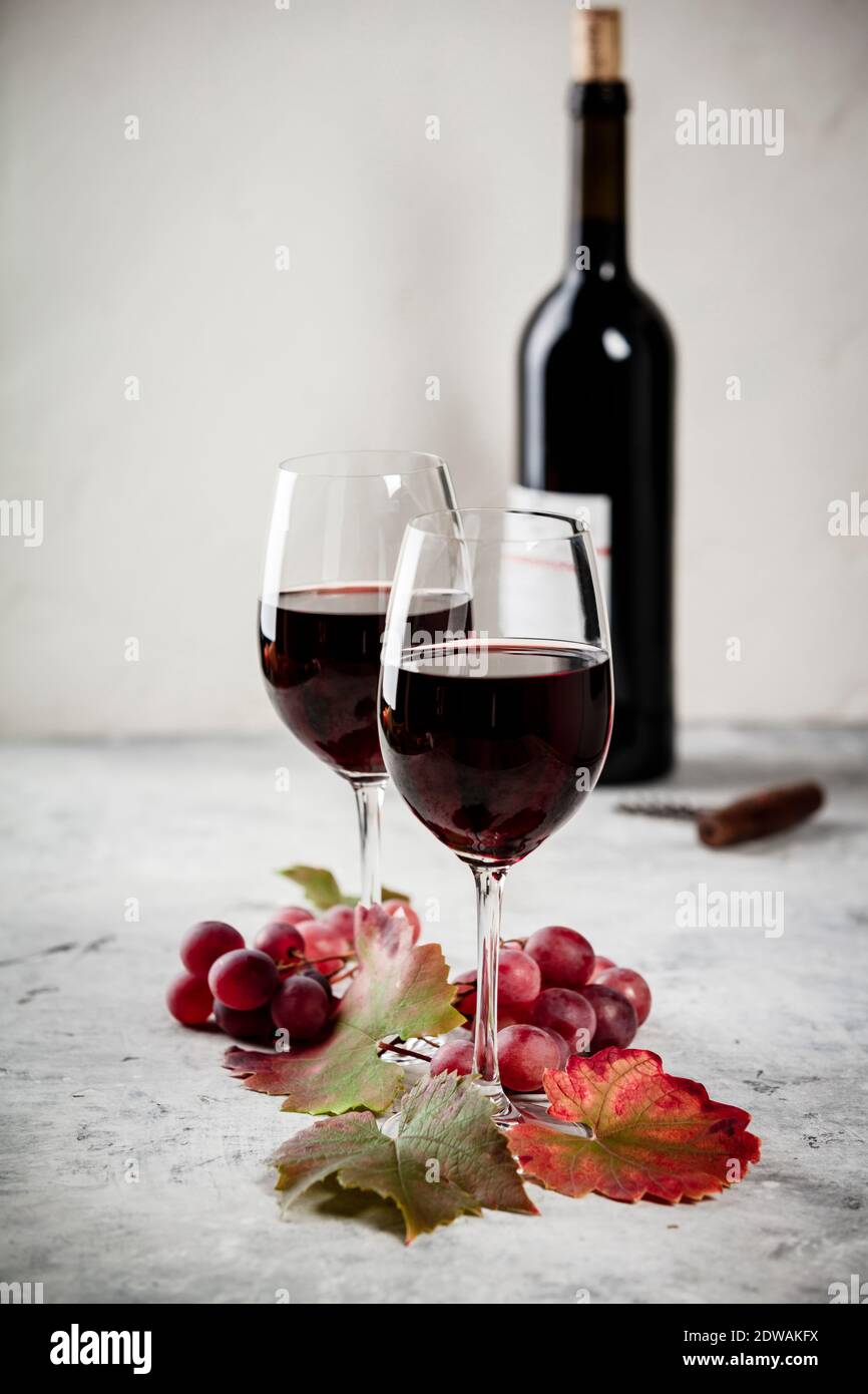Red wine composition. Red wine glasses, bottle of wine, grapes and ...