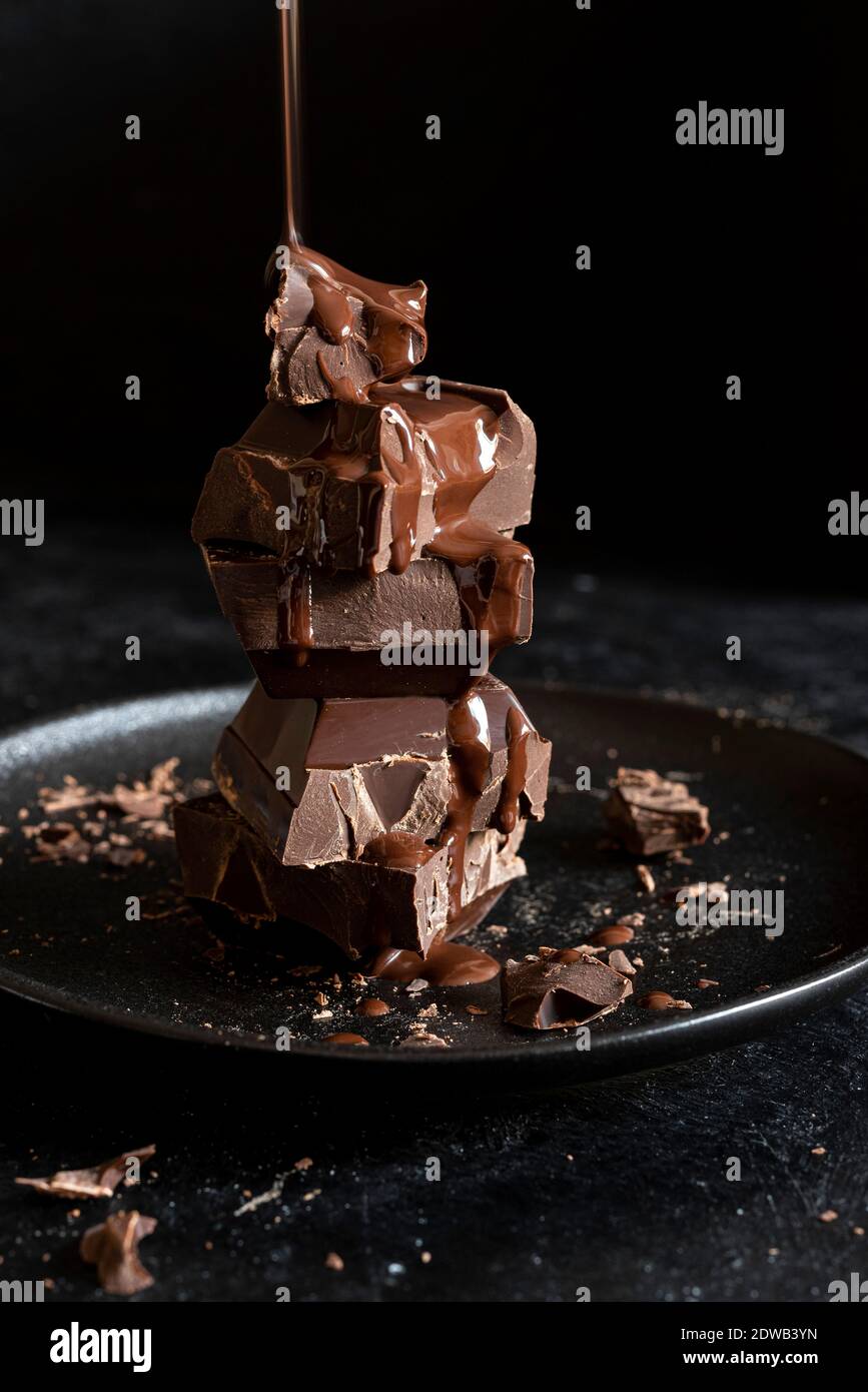 Stack of chocolate cubes on black background Stock Photo - Alamy