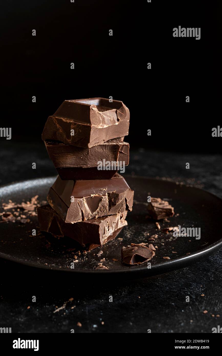 Stack of chocolate cubes on black background Stock Photo - Alamy