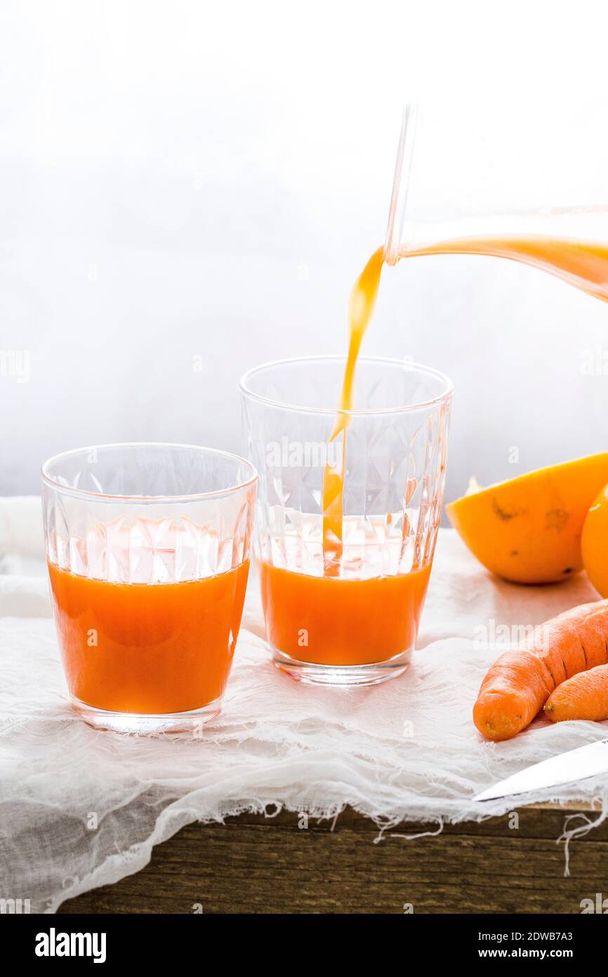 Orange juice pouring in glass hi-res stock photography and images - Alamy