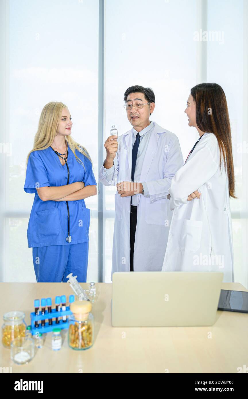 Group of doctors wearing formal white coat and blue scrubs suit ...