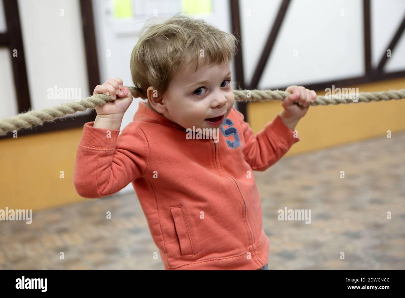 Child playing with rope at indoor playground Stock Photo - Alamy