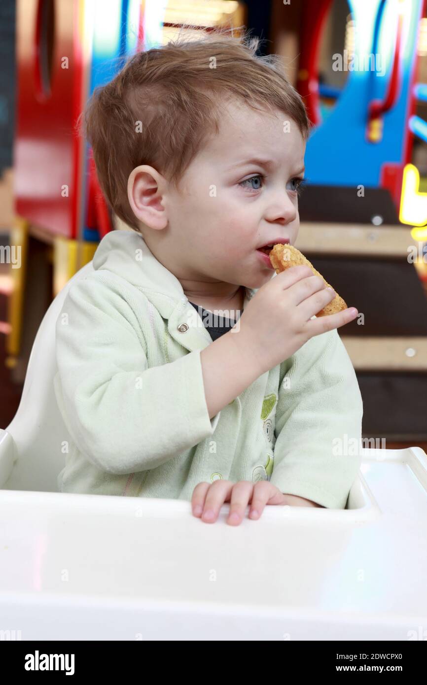 Child eating biscuit hi-res stock photography and images - Alamy