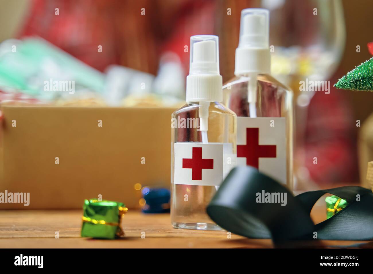 Alcohol antiseptics with red cross logo on wooden table. Concept of ...