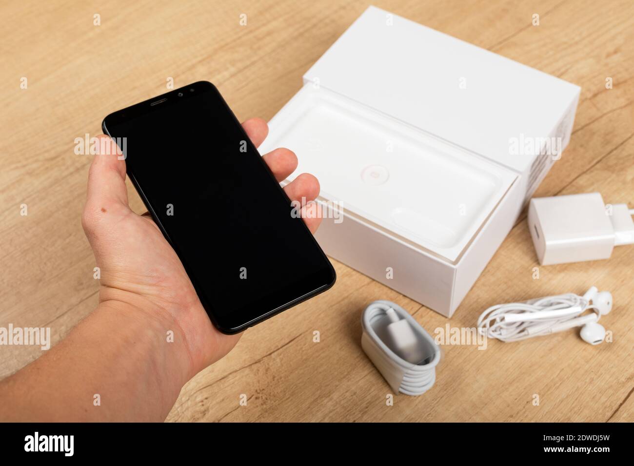 Picture of new smartphone unboxing in front of wooden background Stock ...