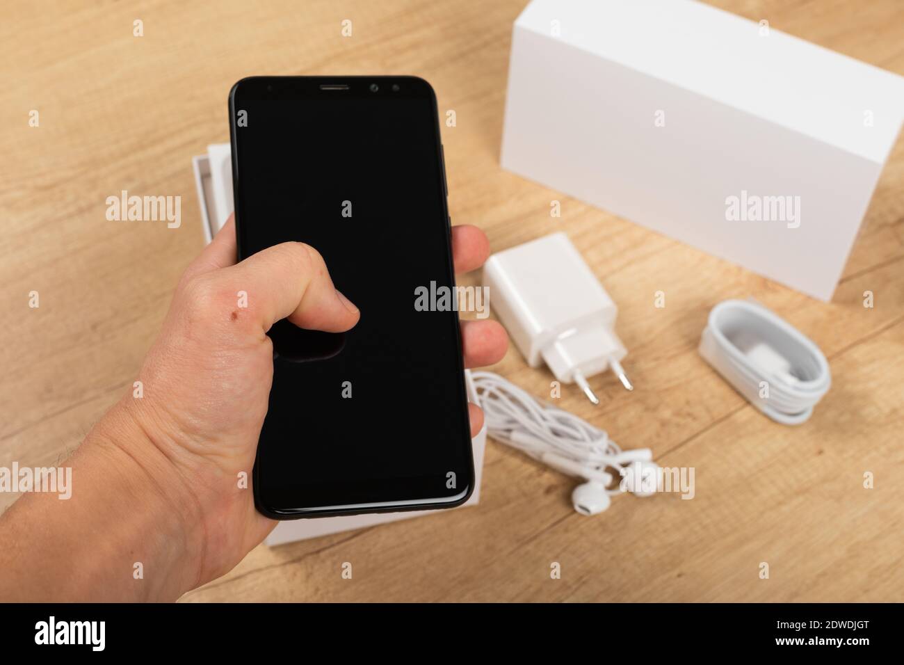 Picture of new smartphone unboxing in front of wooden background Stock ...