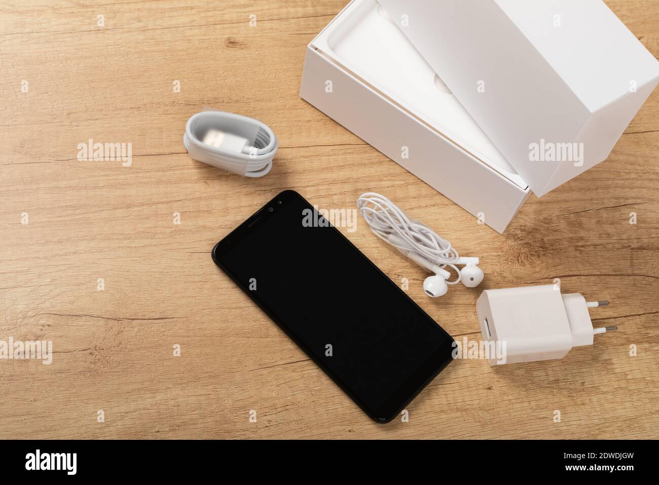 Picture of new smartphone unboxing in front of wooden background Stock ...