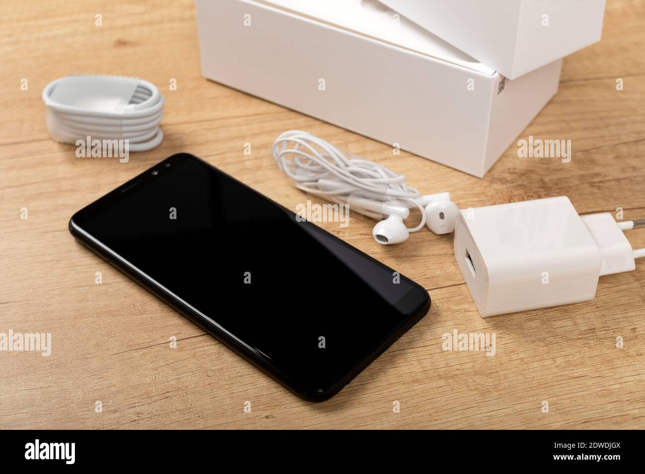 Picture of new smartphone unboxing in front of wooden background Stock ...