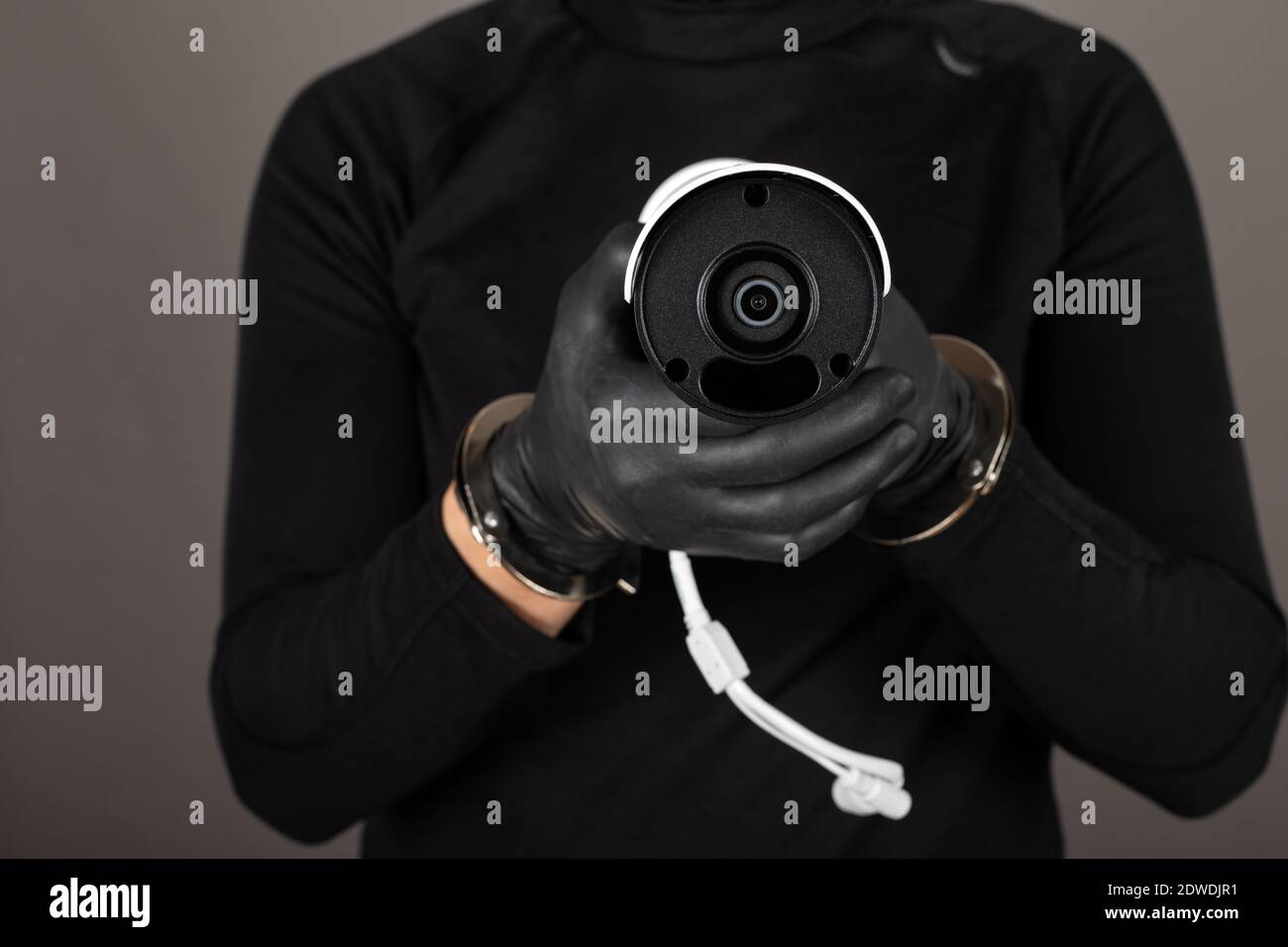 Close up picture of burglars hands turning off surveillance camera on ...