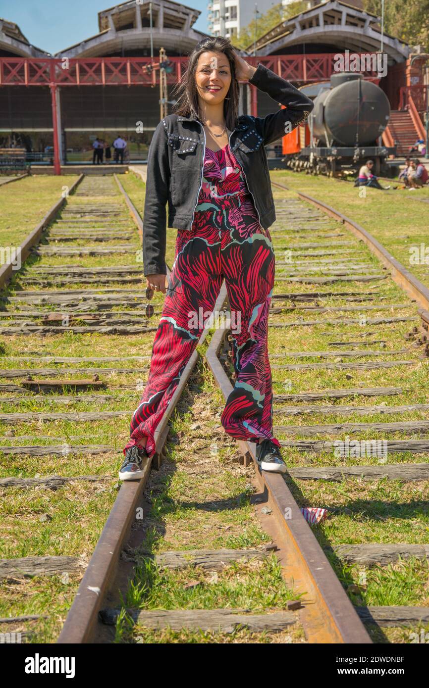 Portrait Of Smiling Woman Standing On Railroad Track Stock Photo - Alamy