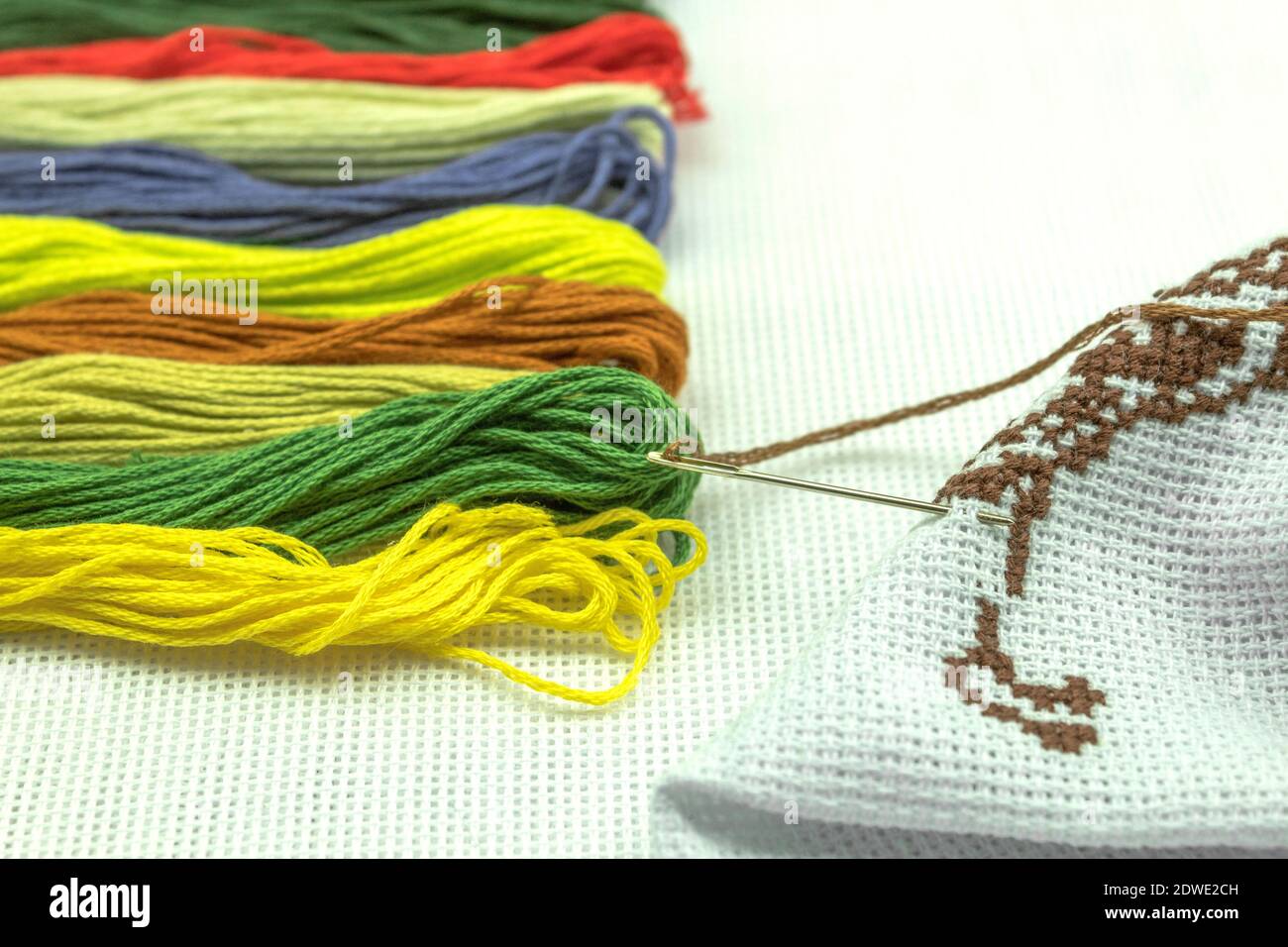Threads of different colors for embroidery. Needle and thread as ...