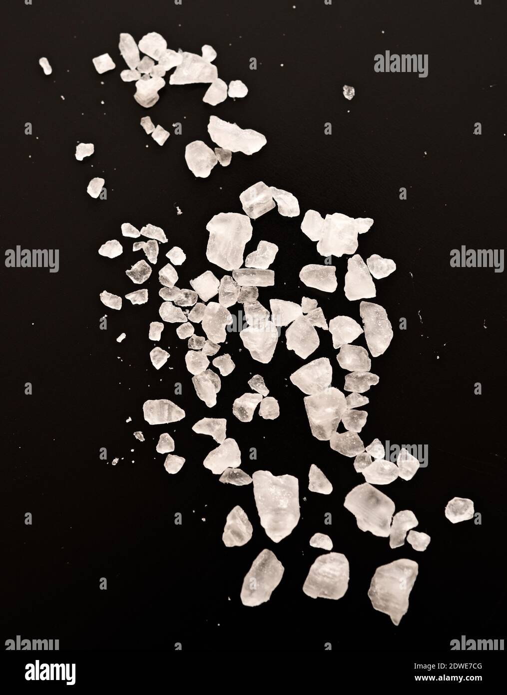 Sea salt on a black background Stock Photo - Alamy