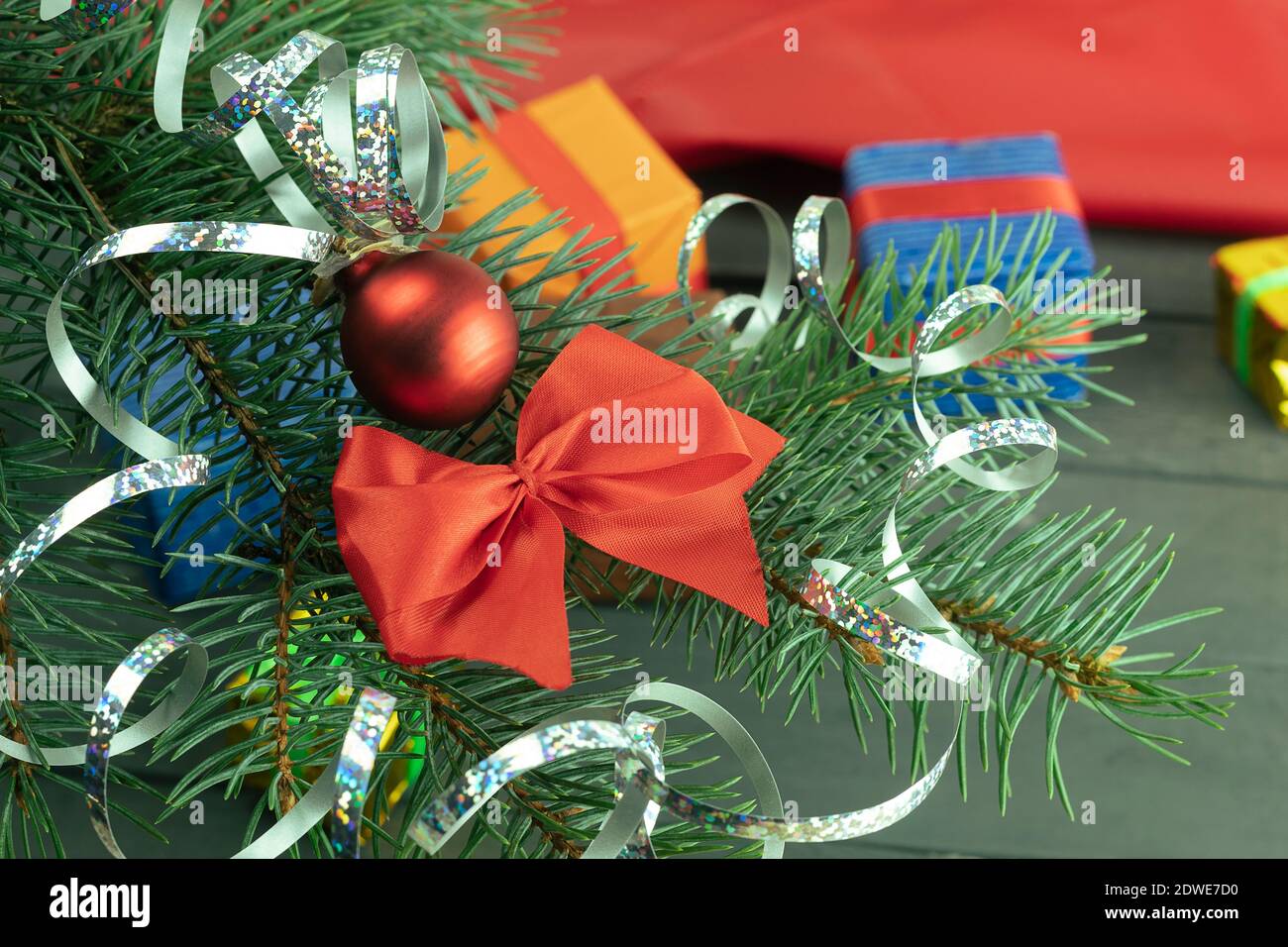 Christmas and New Year gifts in festive packaging under the tree. Make ...