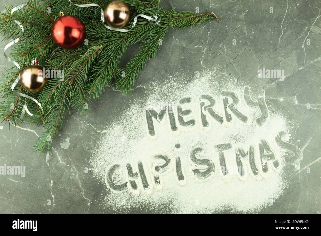 Merry christmas text is written on flour while baking cookies. Text ...