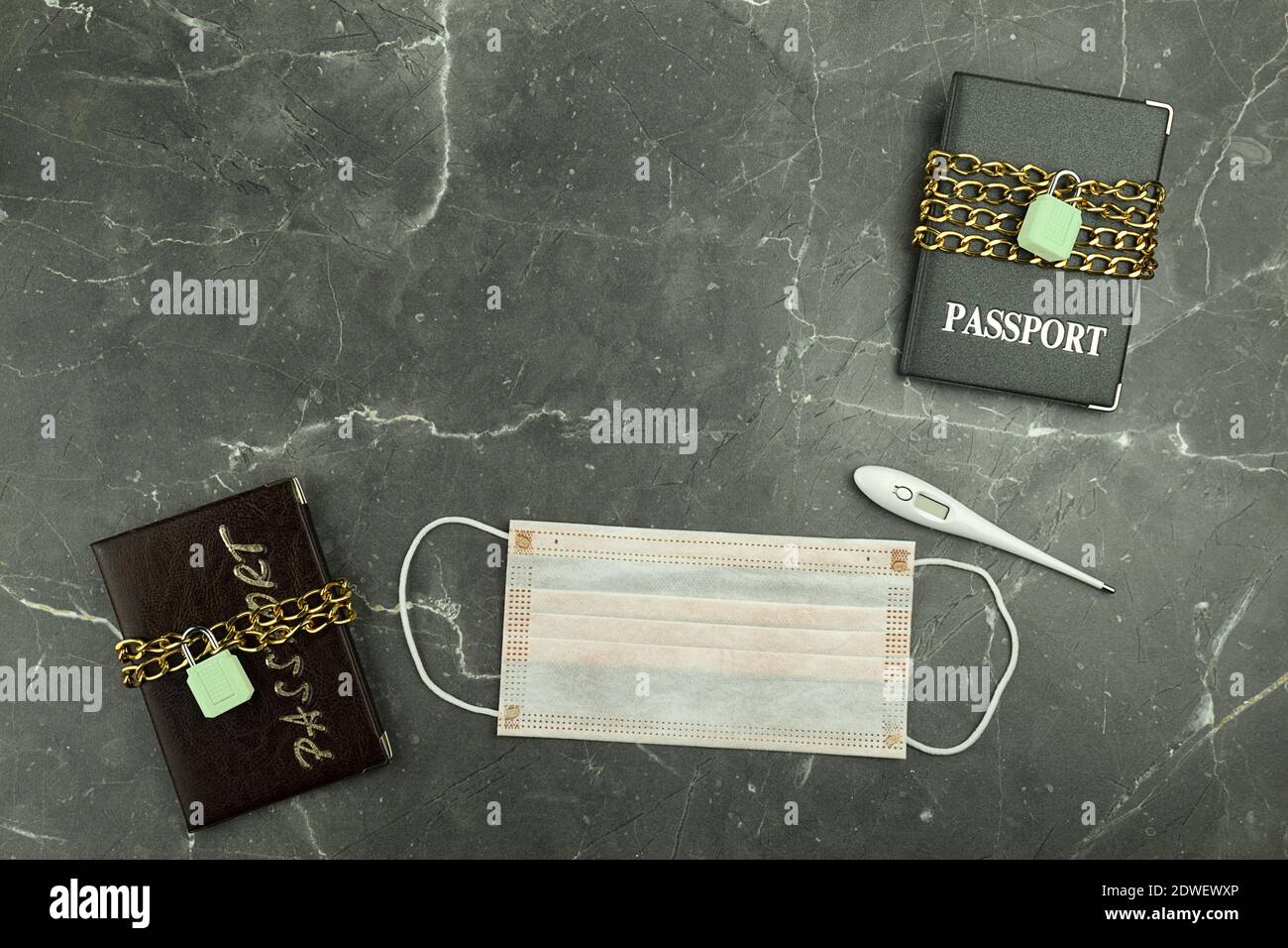 Two passports are wrapped in a chain with a lock. Concept idea there is ...