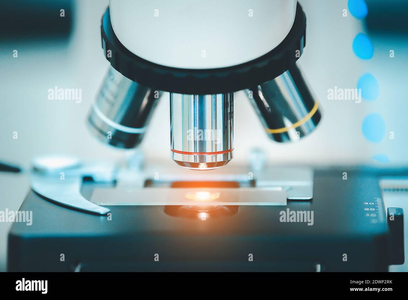 Close up of microscope with test sample in medical research lab or ...