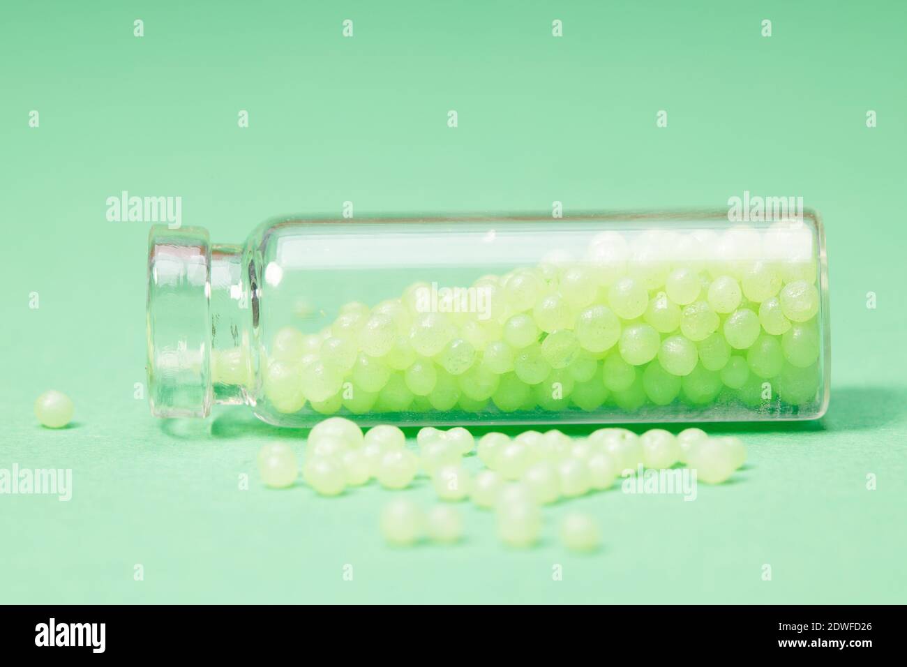 bottle with cork with green granules on a green background Stock Photo ...