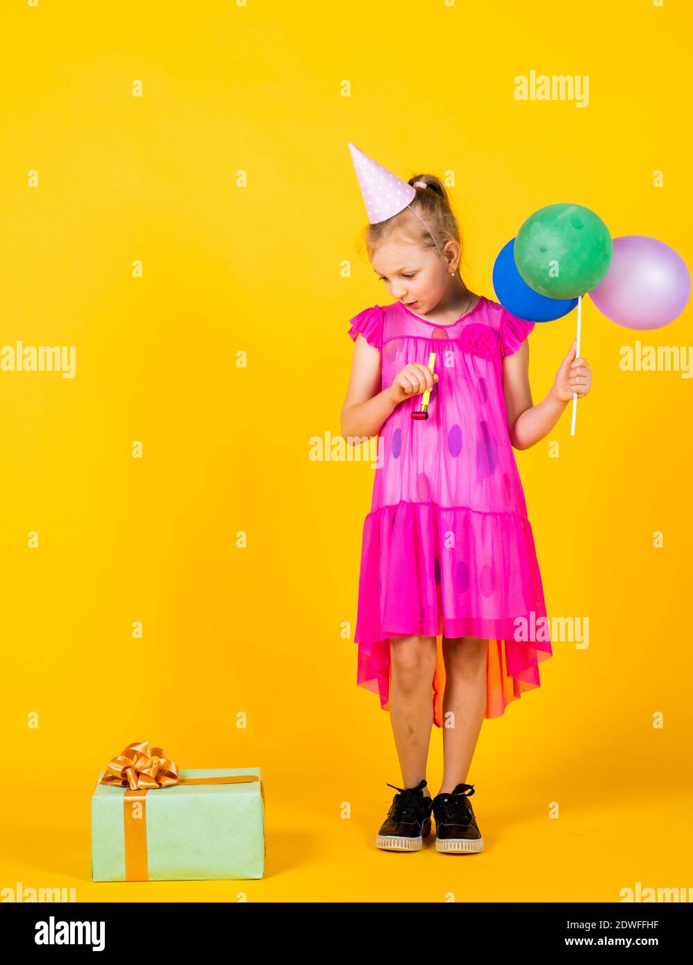 cute kid in dress hold party balloons and gift box, party Stock Photo ...