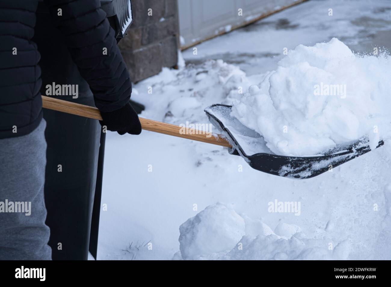 Clearing snow from driveway after heavy winter storm Stock Photo - Alamy