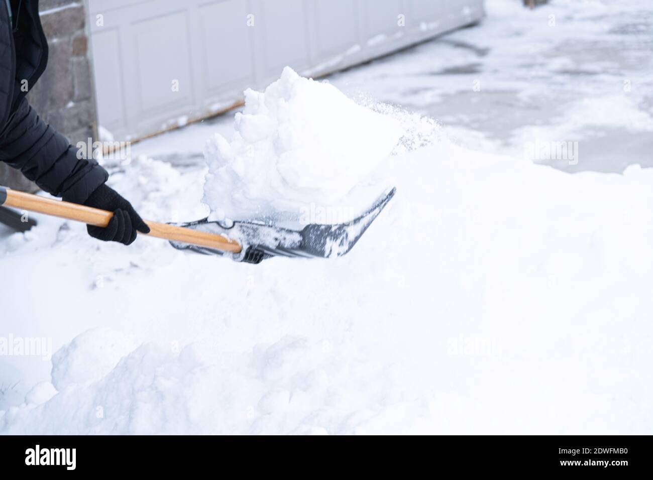 Clearing snow from driveway after heavy winter storm Stock Photo - Alamy