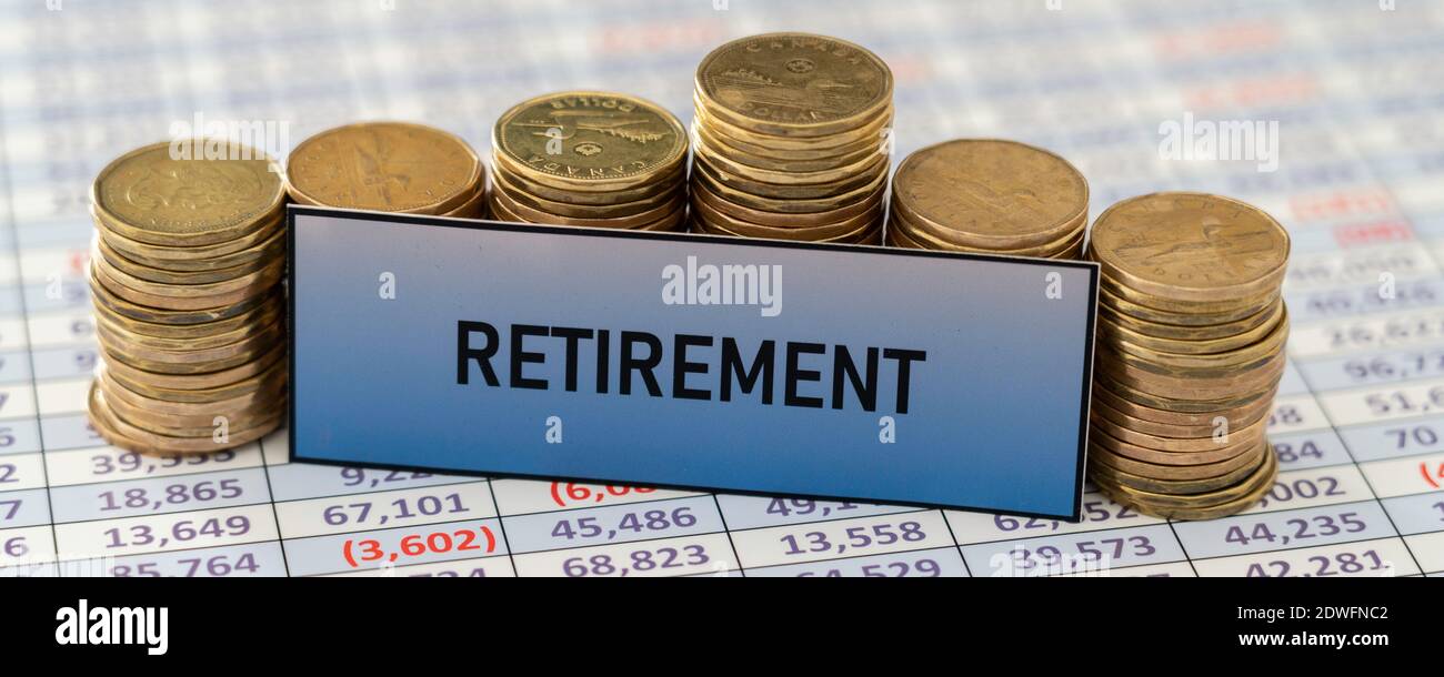 Stacks of Canadain Dollar Coins on a spreadsheet with retirement sign ...